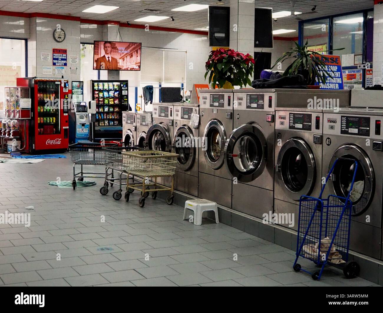 Interior of Brooklyn laundromat with silver washing machines and ...