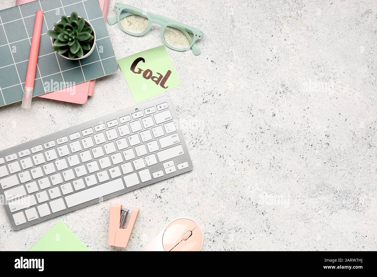 Sticky note with word GOAL, stationery, computer keyboard and ...