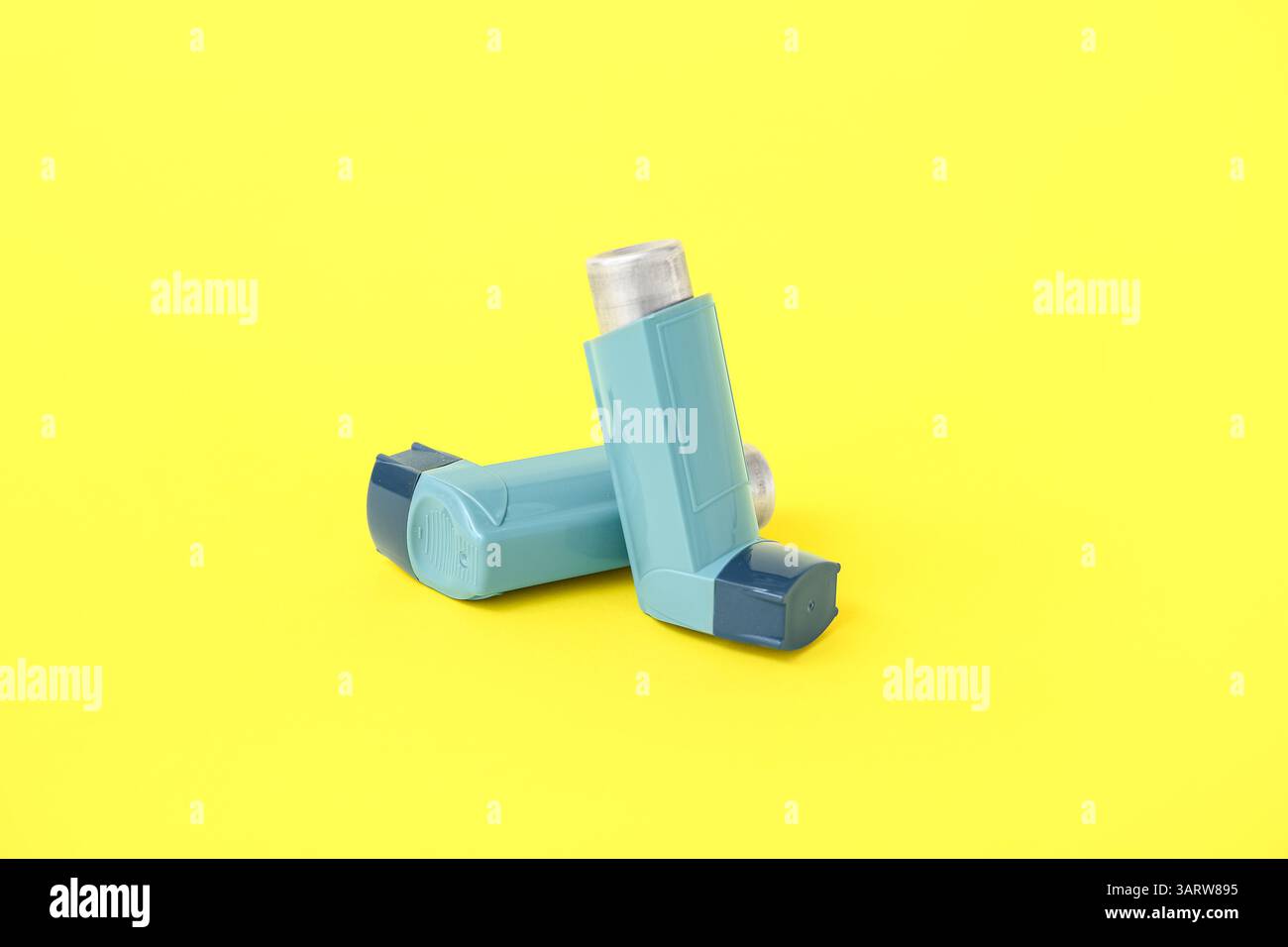 Asthma inhalers on yellow background Stock Photo - Alamy