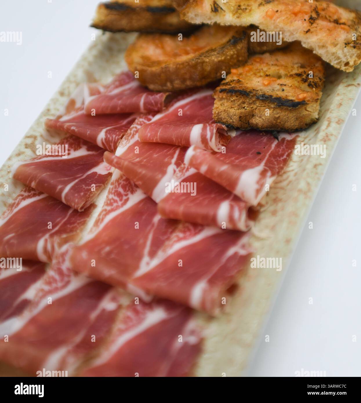 Spanish tapas platter with jamon serrano and croutons Stock Photo - Alamy