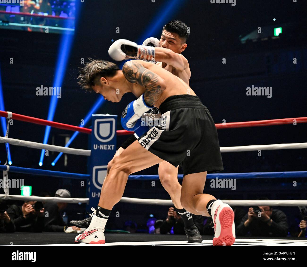 Tokyo, Japan. 13th Mar, 2025. Japan's Tomoya Tsuboi (white gloves) throws a left at Thailand's ...