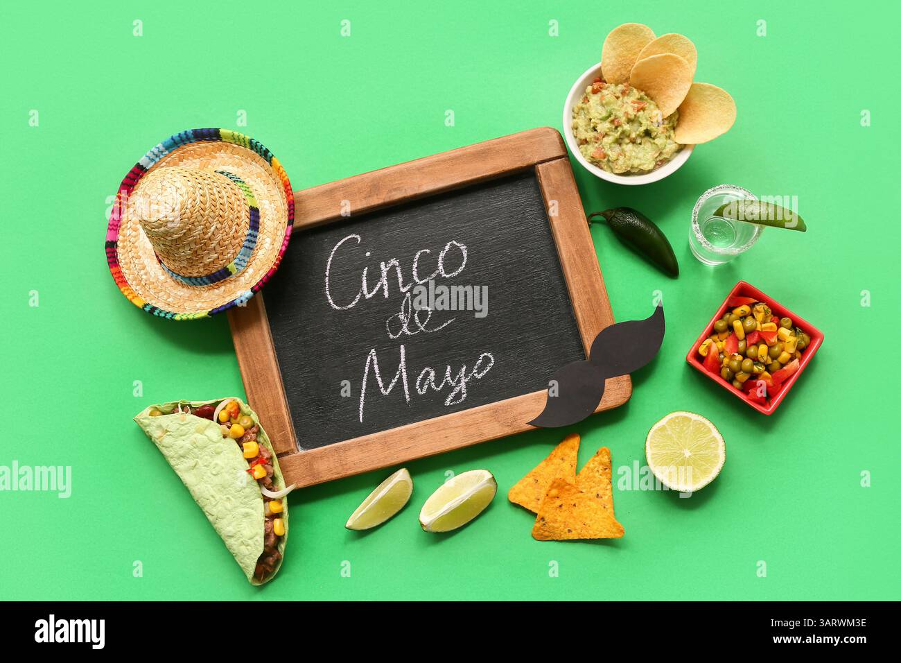 Traditional Mexican food and text CINCO DE MAYO written on chalkboard ...