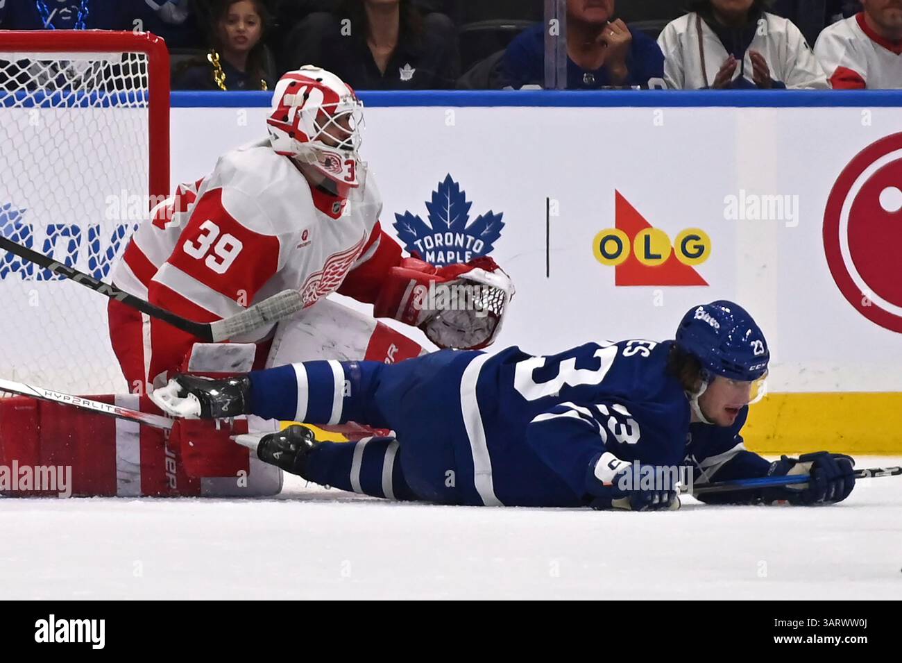 Toronto Maple Leafs' Matthew Knies (23) falls in front of Detroit Red ...