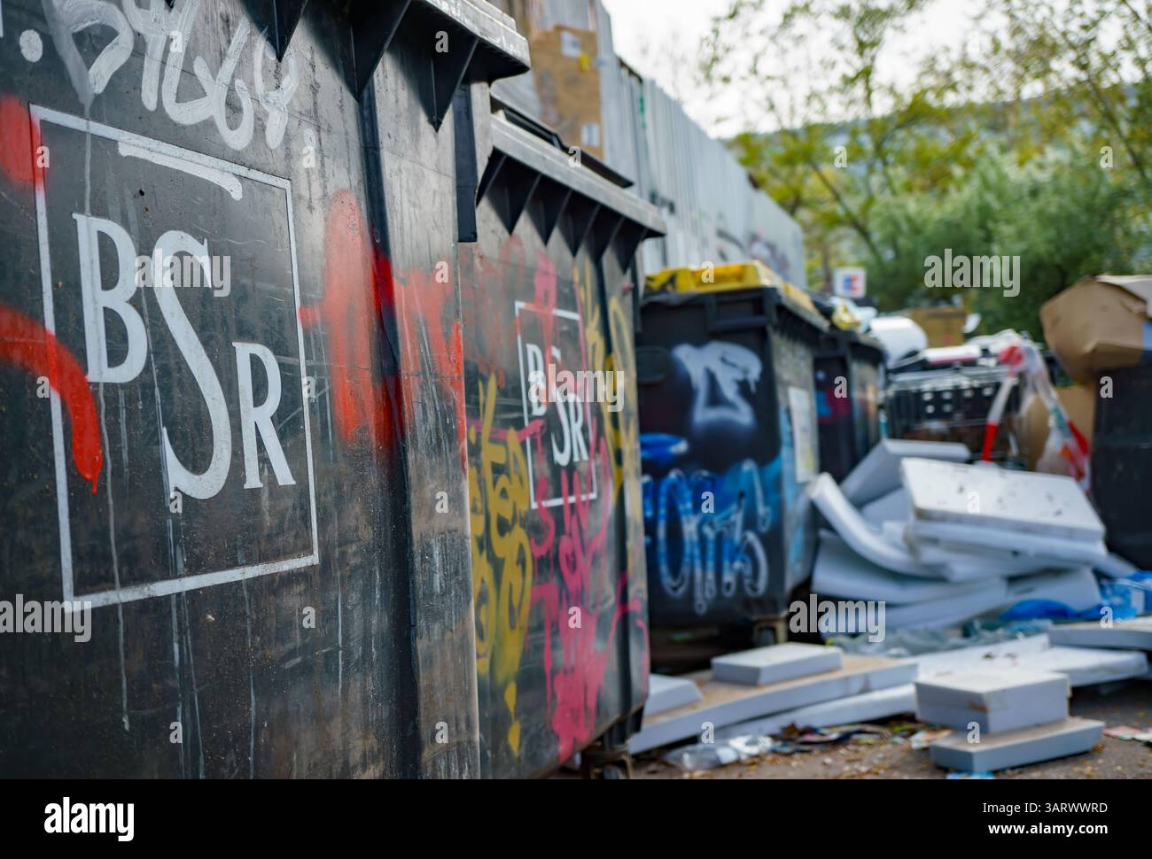 Overflowing BSR waste bins covered in graffiti, surrounded by bulky ...