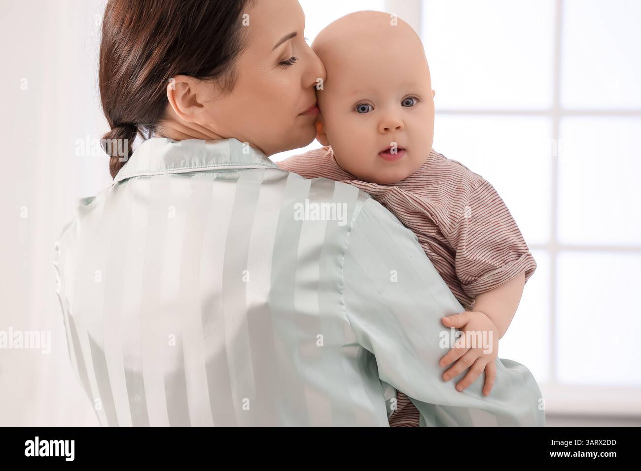 Happy mother hugging her little baby in bedroom, back view Stock Photo - Alamy