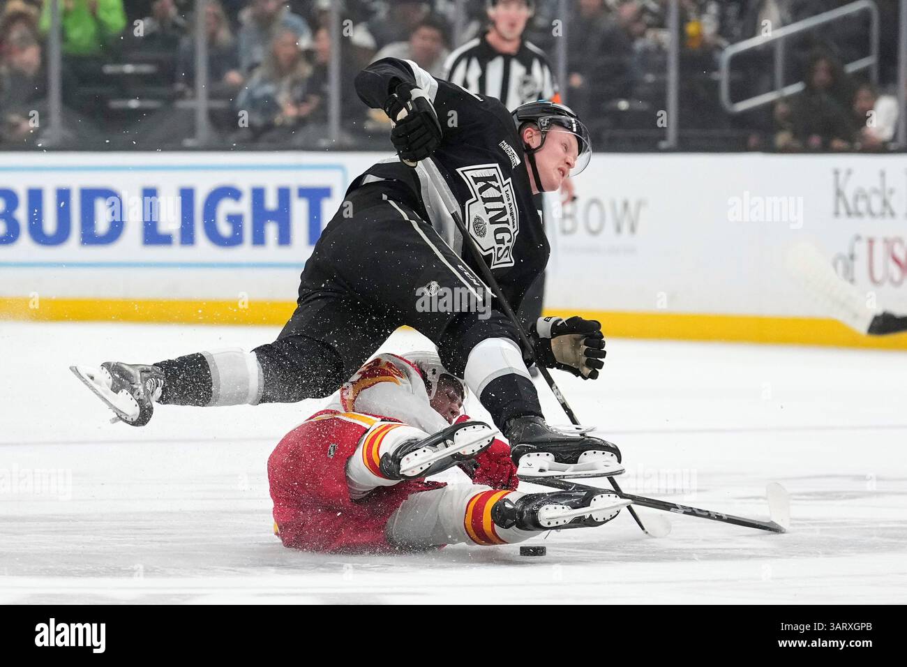 Los Angeles Kings center Samuel Helenius, top, trips over Calgary ...