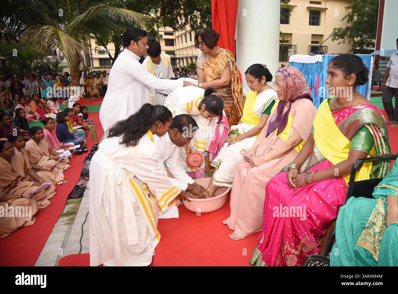 PATNA, INDIA - APRIL 17: Christian priest washing legs of Christian ...