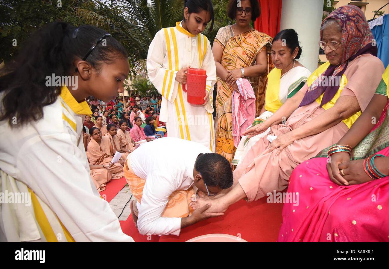 PATNA, INDIA - APRIL 17: Christian priest washing legs of Christian ...