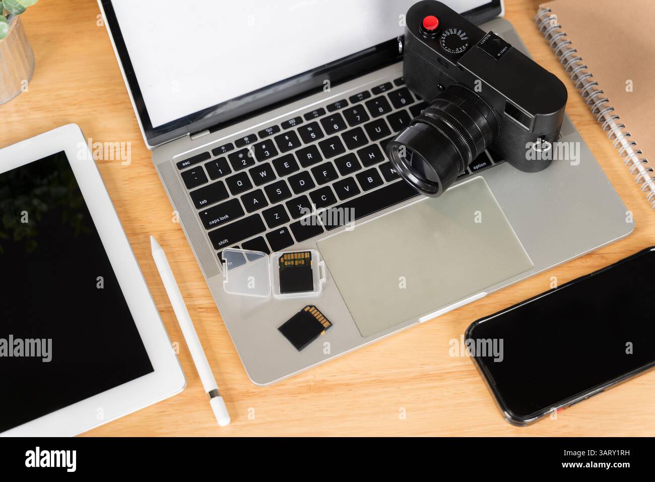 Top view. Flat lay. Laptop, external hard drive, modern digital camera ...