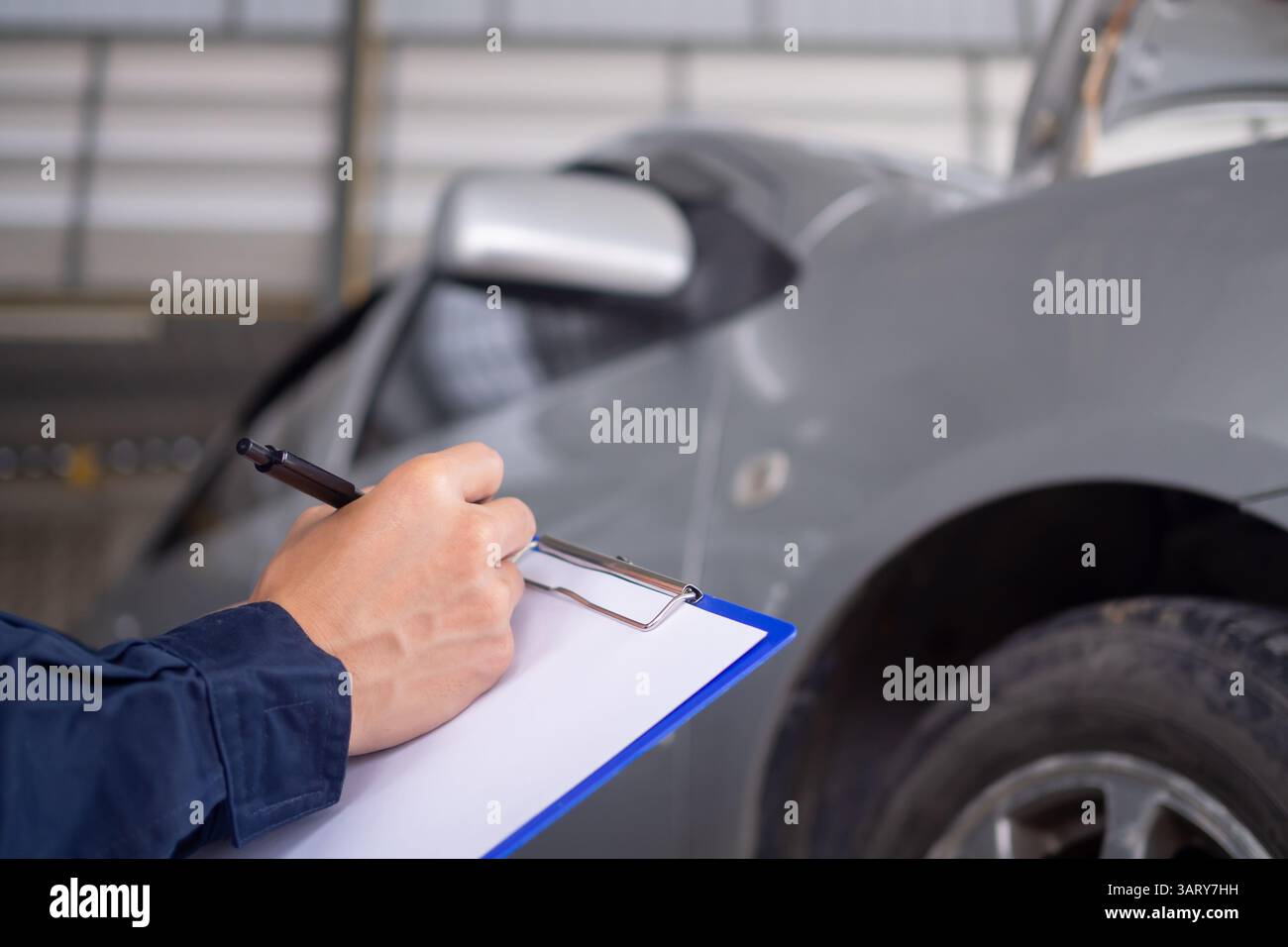 mechanic is doing the annual car inspection. Car repair shop is ready ...
