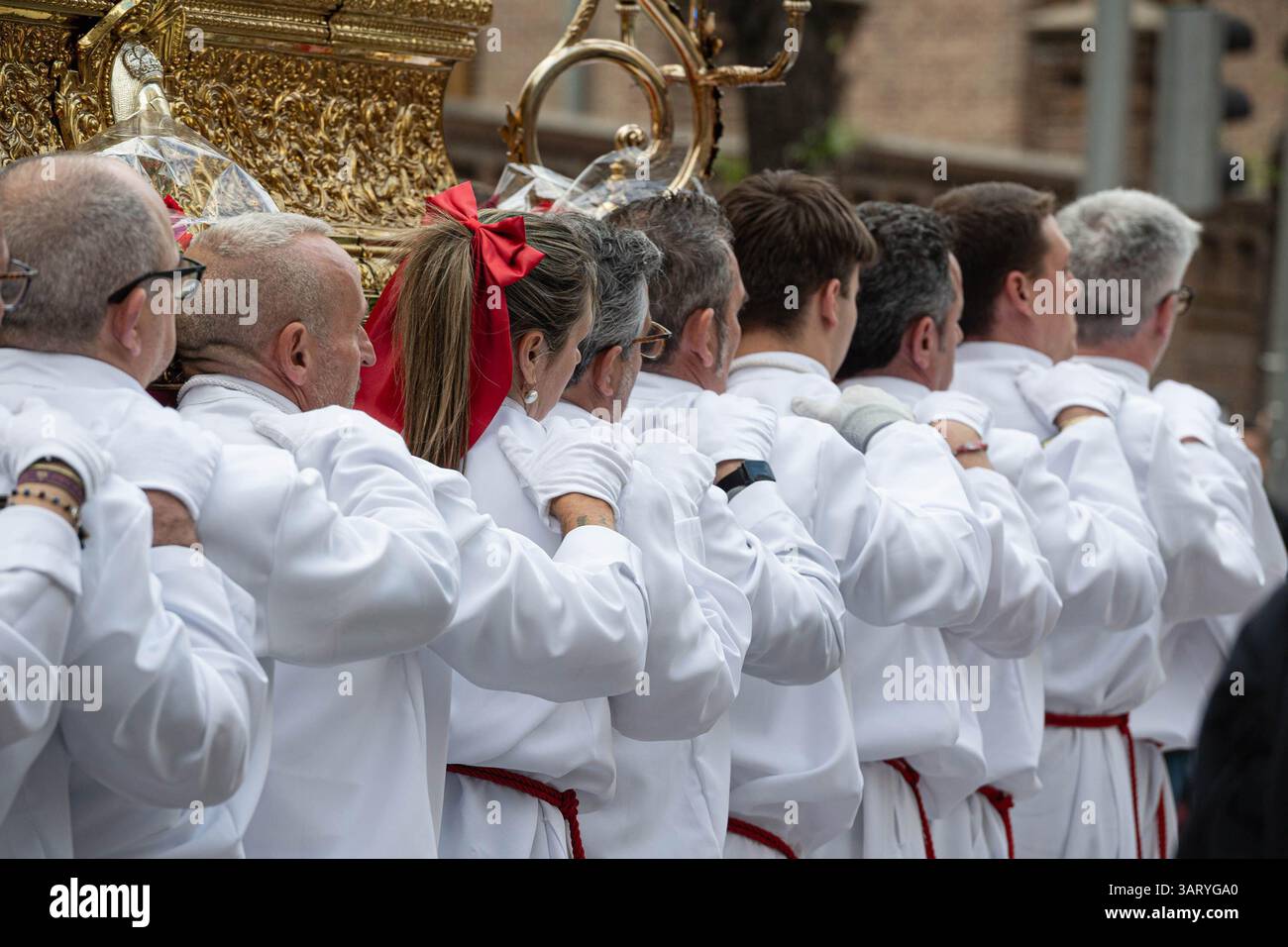 Madrid, Spain. 17th Apr, 2025. Back view of costaleros in white robes ...