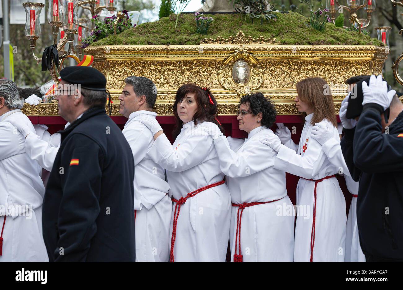 Madrid, Spain. 17th Apr, 2025. Costaleros carry an ornate Holy Week ...