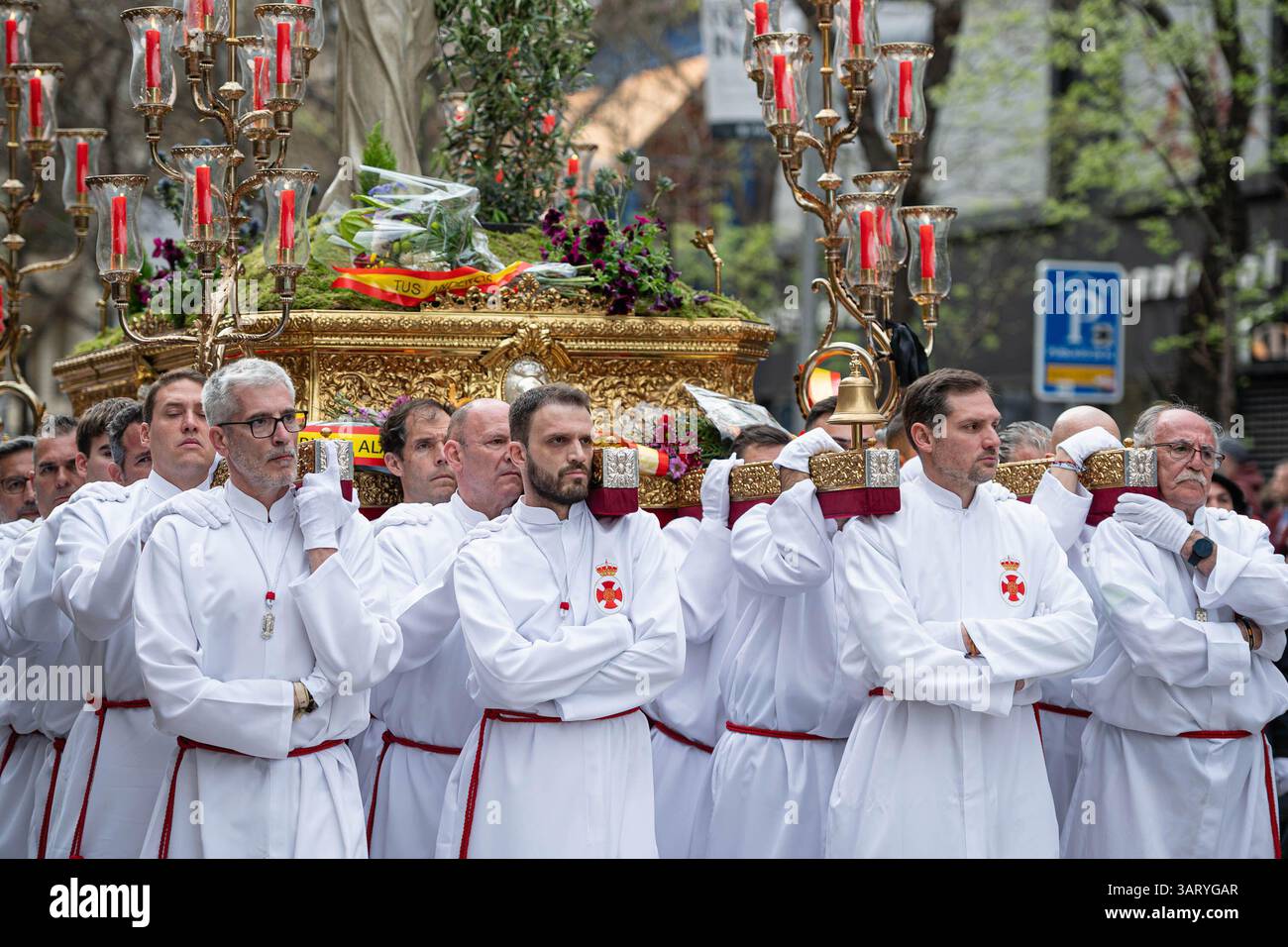 Madrid, Spain. 17th Apr, 2025. Costaleros carrying an ornate gilded ...