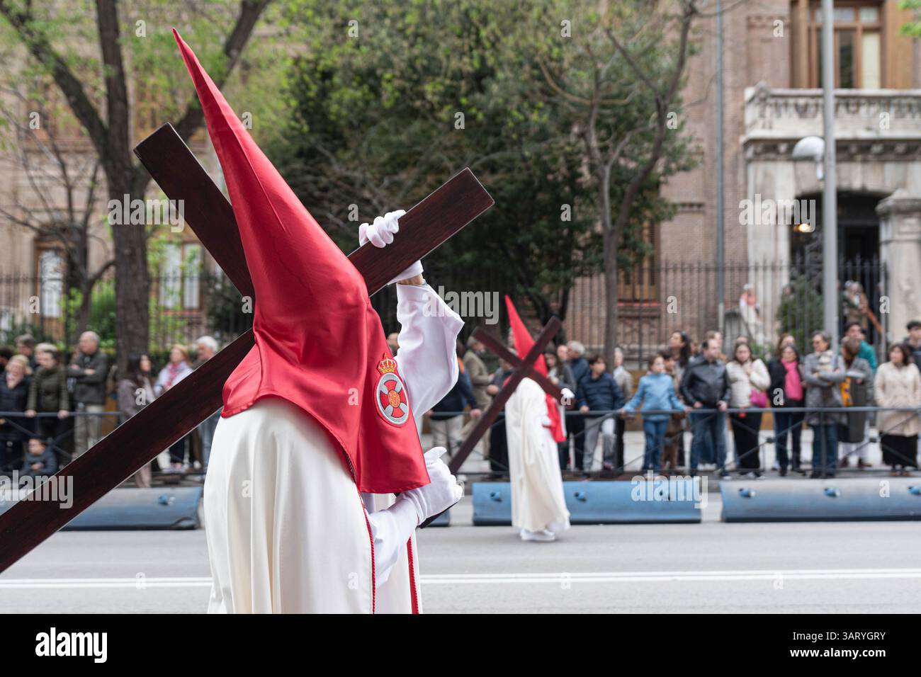 Madrid, Spain. 17th Apr, 2025. Nazarenes in white robes and red pointed ...