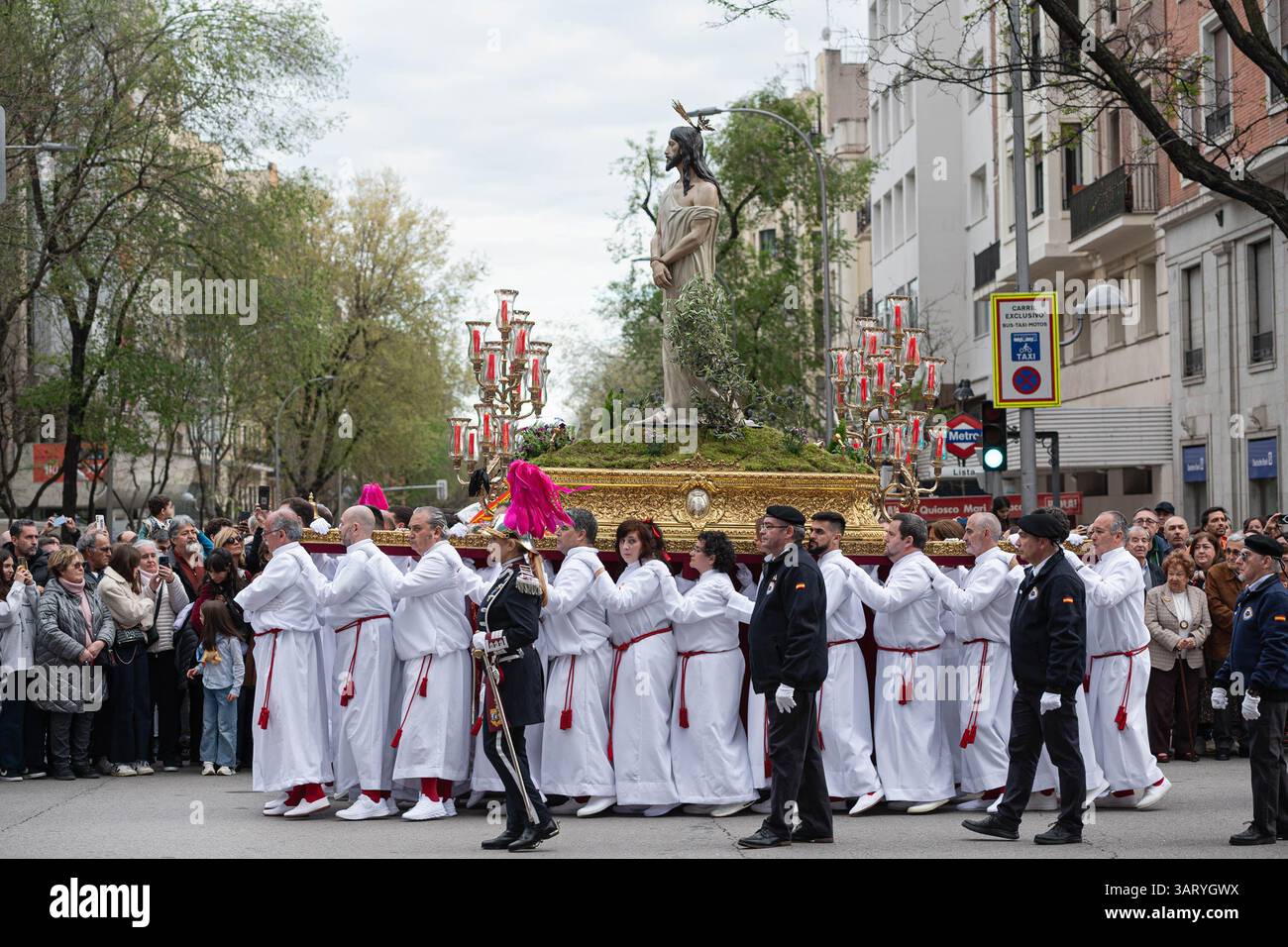 Costaleros carry an ornate Holy Week float with a statue of Jesus ...