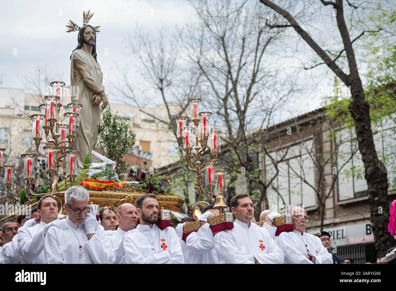 Madrid, Spain. 17th Apr, 2025. Costaleros carry a gilded float with a ...