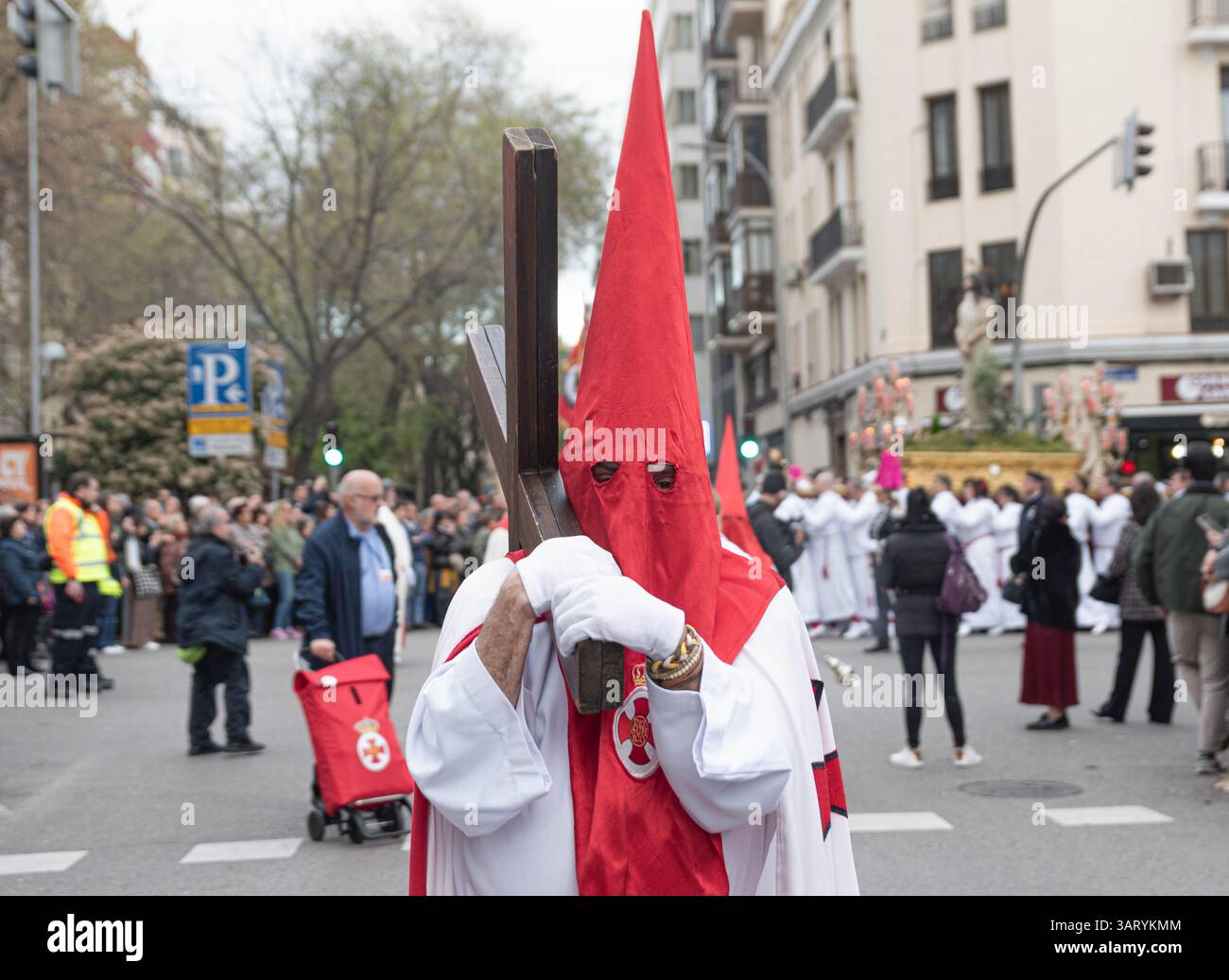 Madrid, Spain. 17th Apr, 2025. Hooded penitent seen carrying a wooden ...