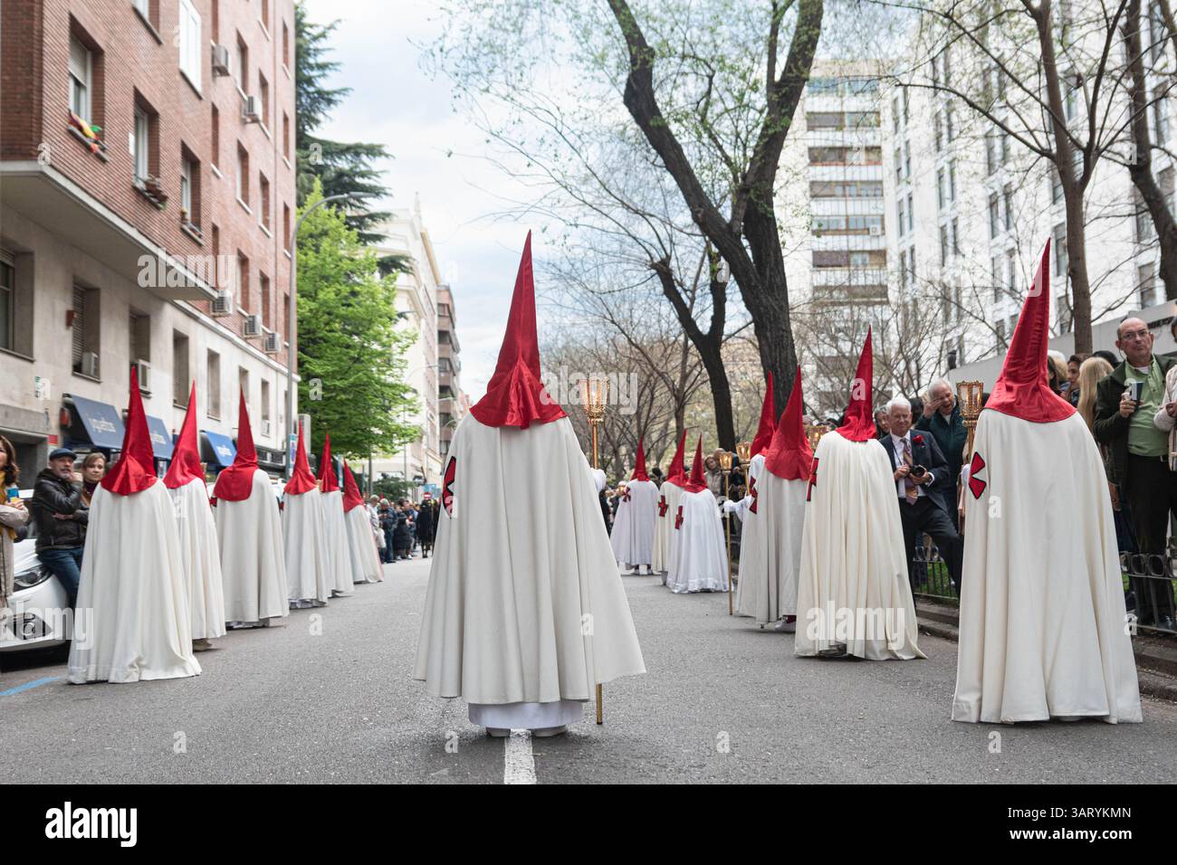 Madrid, Spain. 17th Apr, 2025. Nazarenes in white robes and red pointed ...