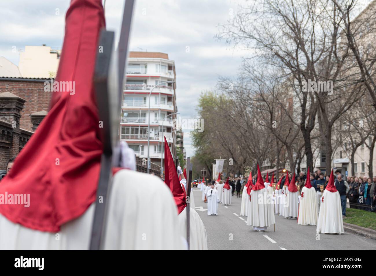 Madrid, Spain. 17th Apr, 2025. Nazarenes dressed in white robes and red ...