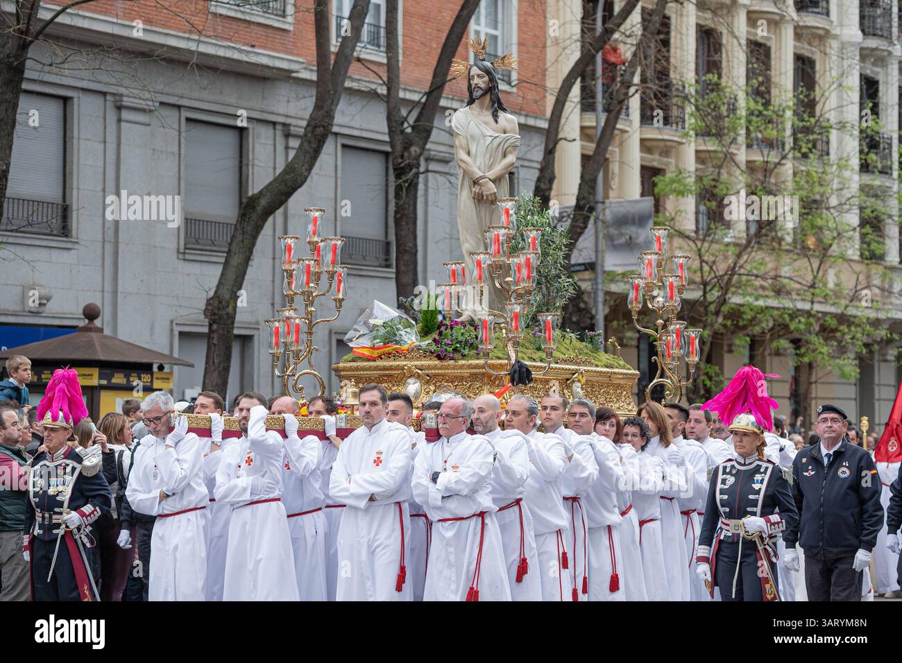 Madrid, Spain. 17th Apr, 2025. Costaleros carry a gilded float with a ...