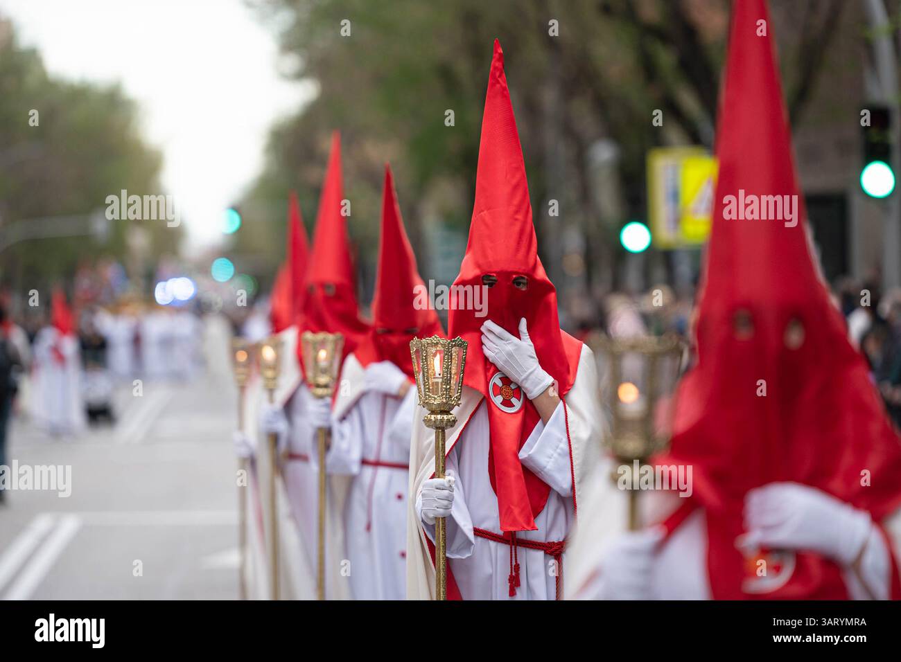 Madrid, Spain. 17th Apr, 2025. Nazarenes in white robes and red pointed ...