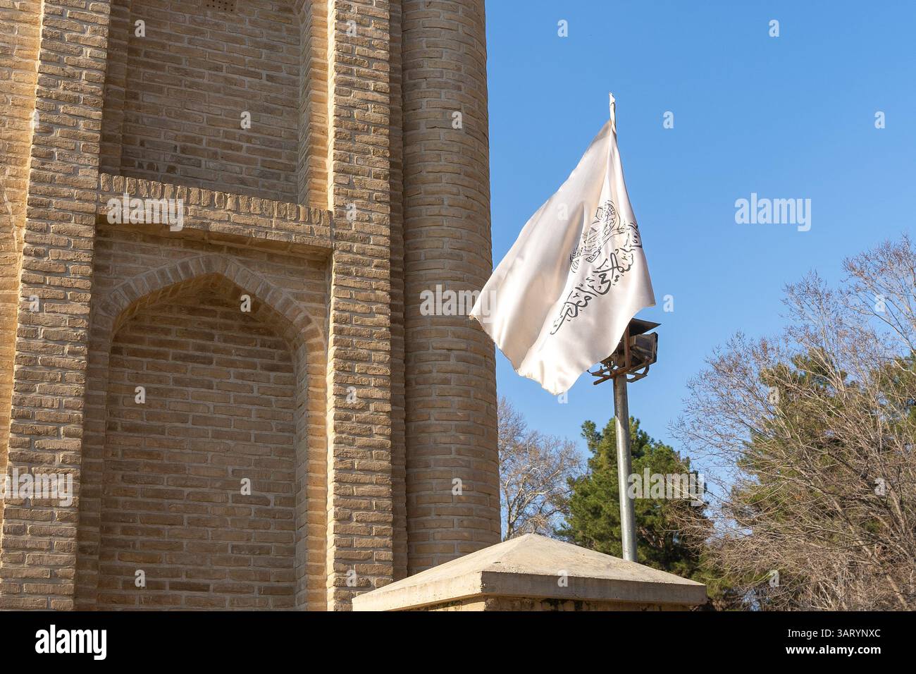 the modern national flag of Afghanistan at the Green Mosque of Balkh ...