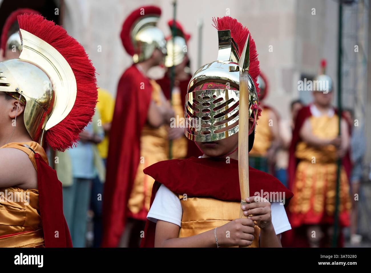 A child dressed as a centurion performs during a Holy Week procession ...