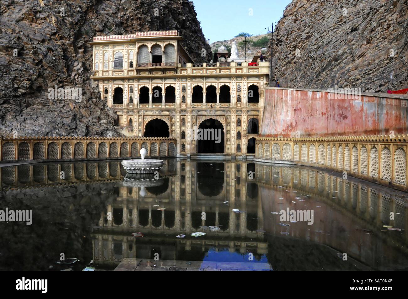 Temple, Galta Gorge, A historic palace is reflected in a tranquil pool ...