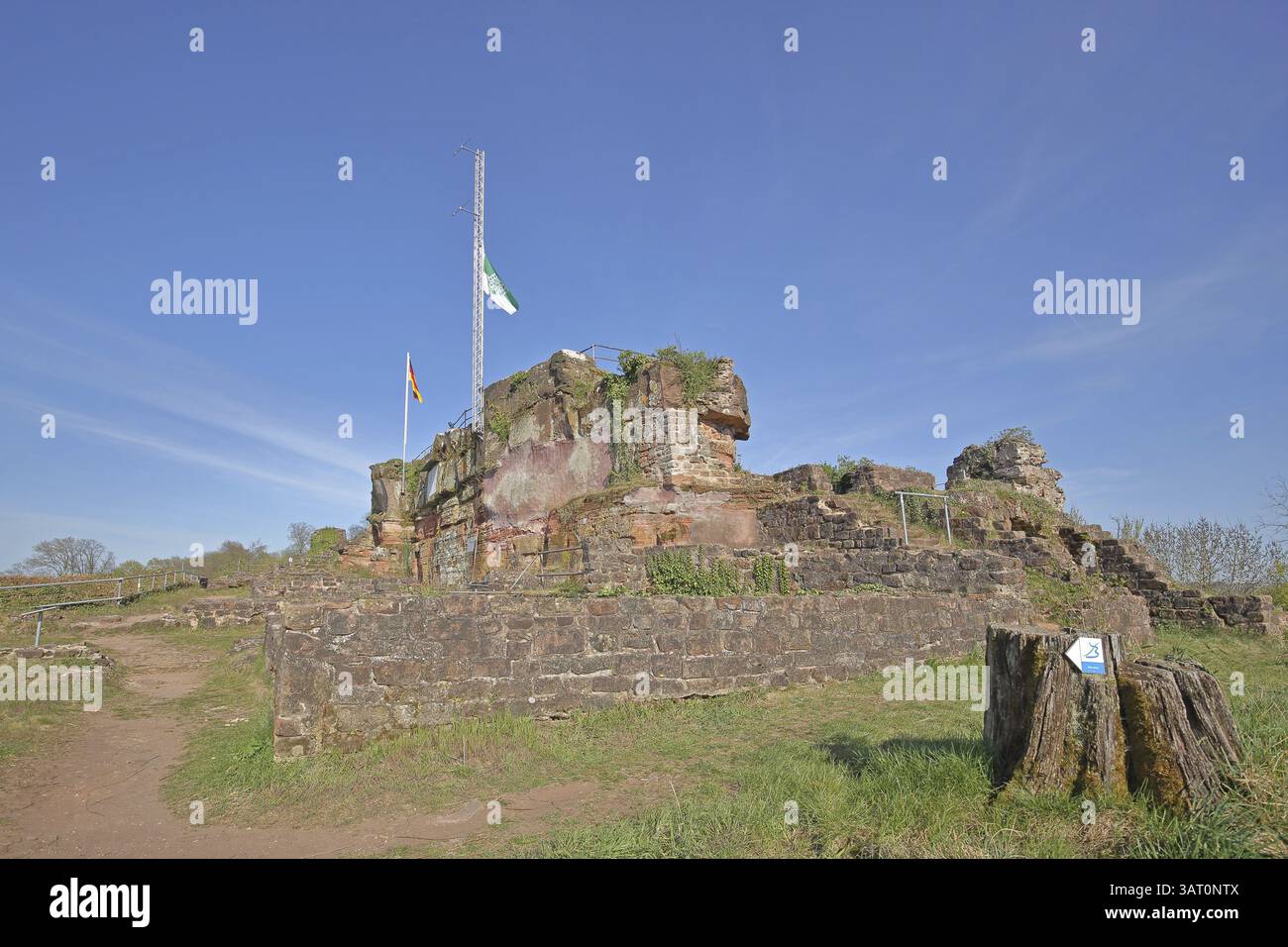 Hohenburg castle ruins with German national flag, red coloured ...