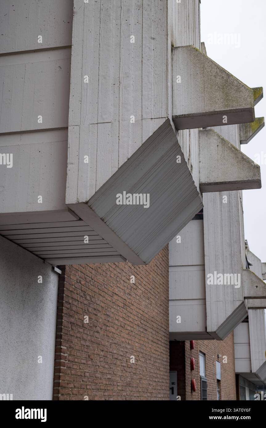 Concrete canopy with geometric shapes extending over the brick wall of ...