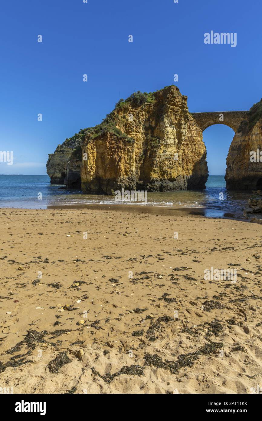 Yellow rocks and cliffs on a sandy beach. A bay by the sea, over which ...
