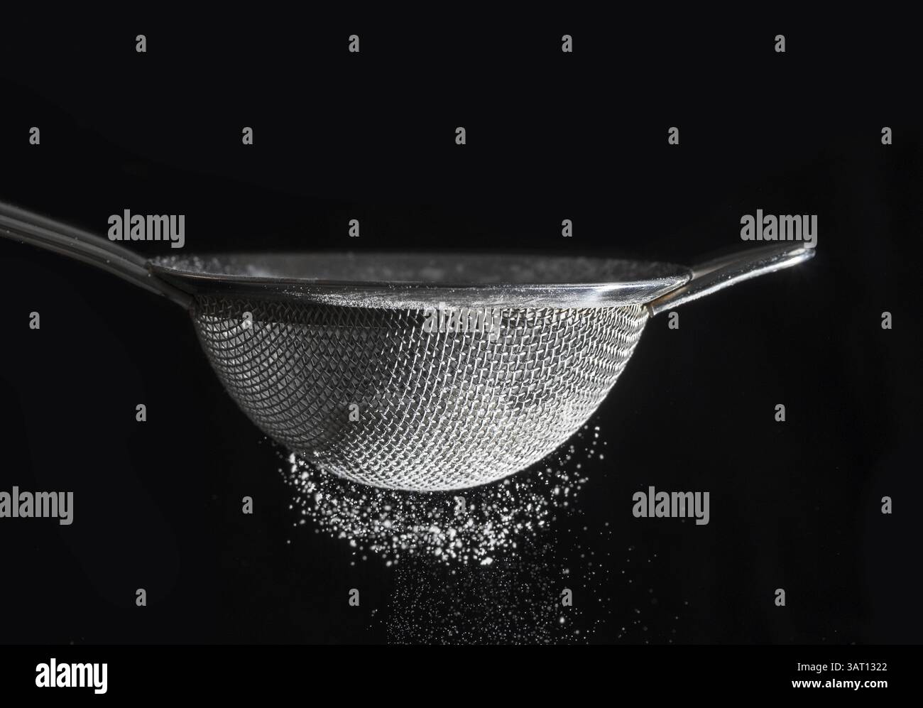 Sieve the flour in a metal sieve Stock Photo - Alamy