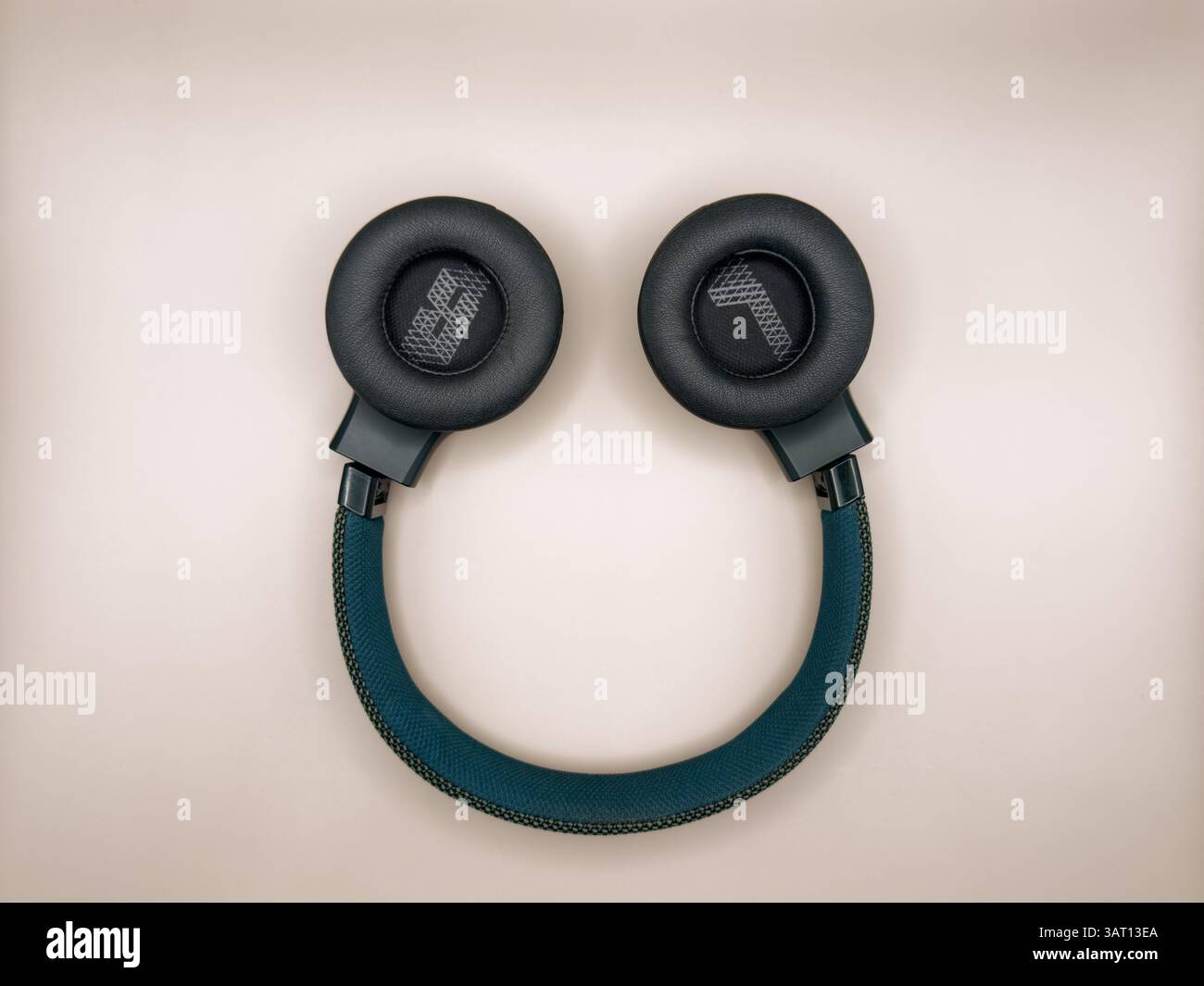 Headphones are full-size, large, green, with soft earphones turned ...