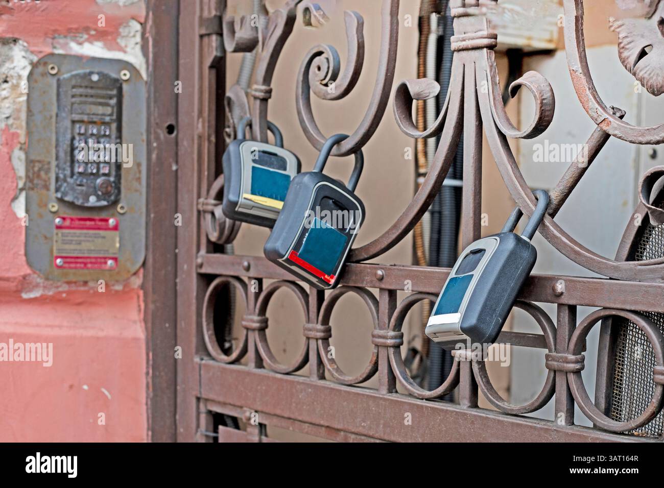 modern locks on forged gates next to the intercom. Protection and ...