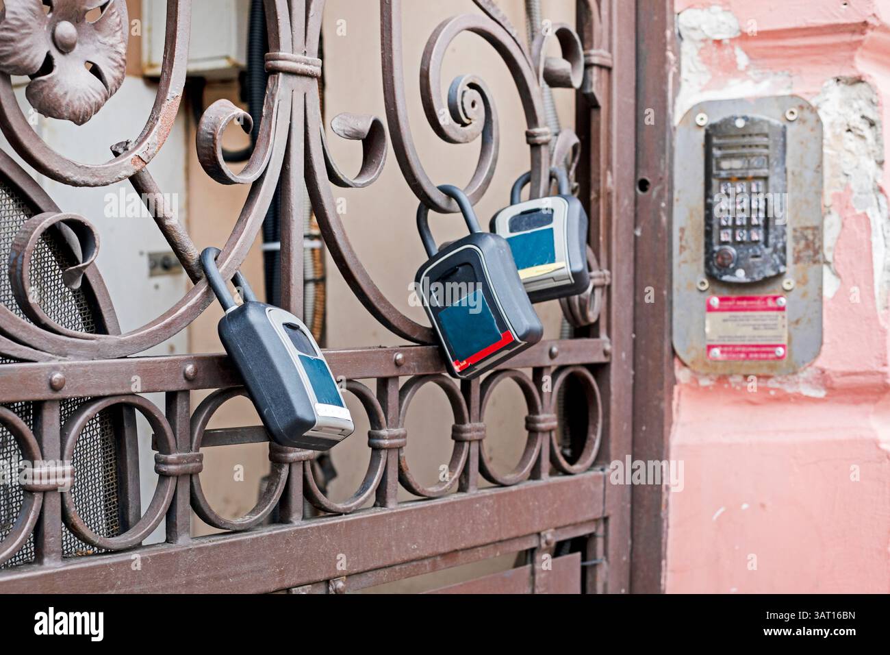modern locks on forged gates next to the intercom. Protection and ...