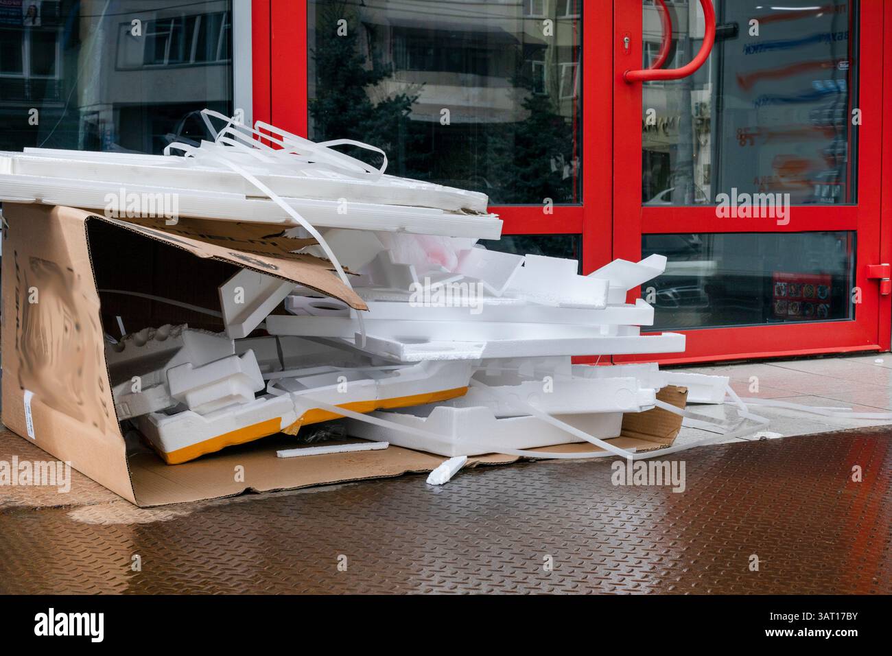 scattered remains of packaging near the office door Stock Photo - Alamy