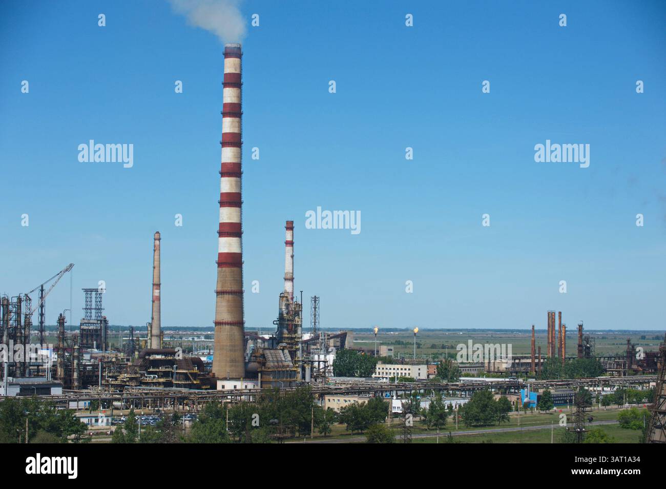 Pipes and cooling towers of a large heating plant Stock Photo - Alamy