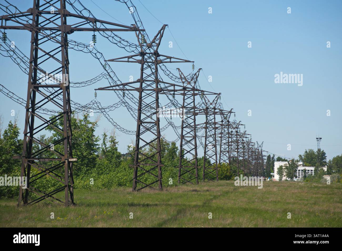 High-voltage towers with power grids Stock Photo - Alamy