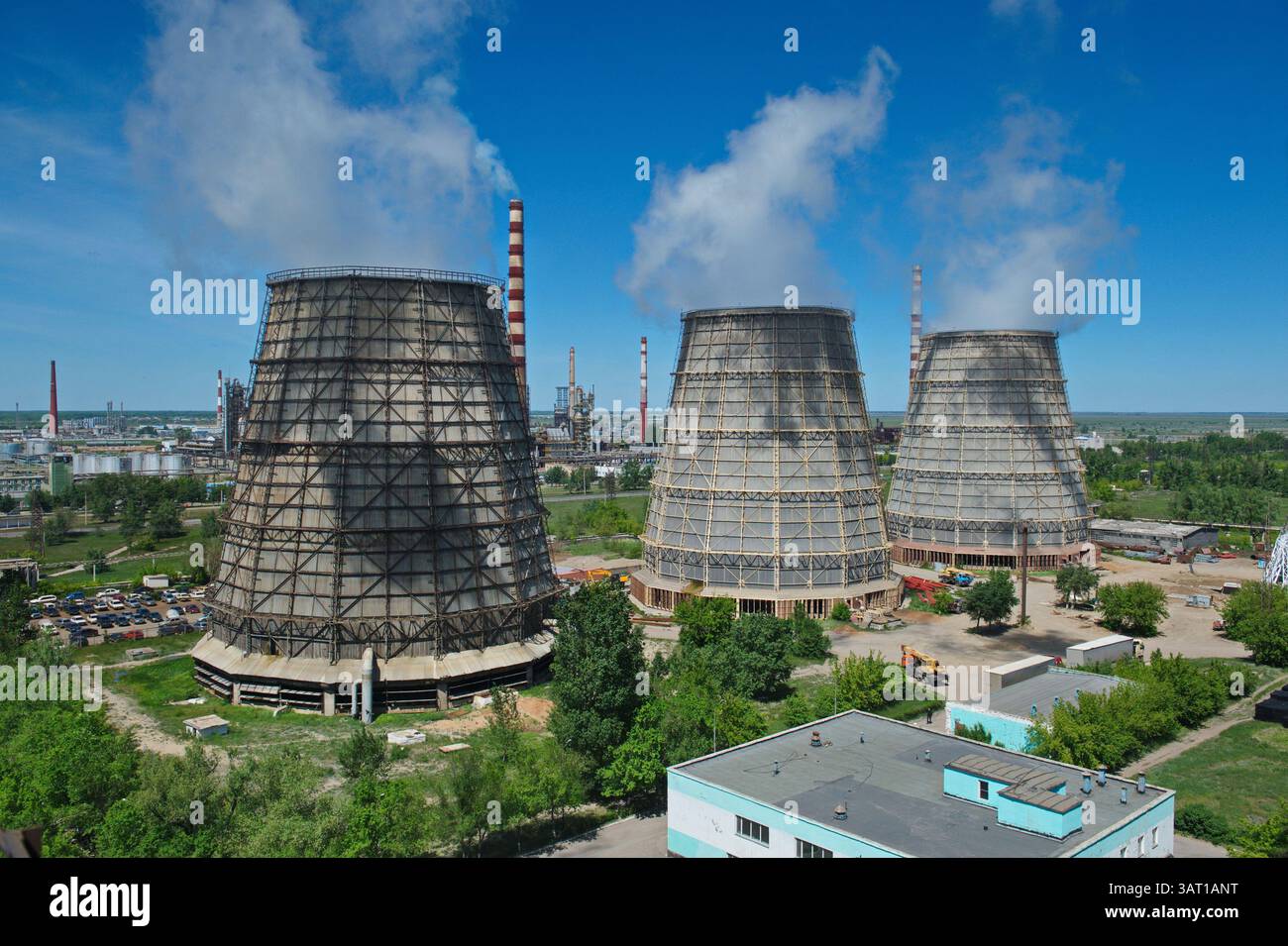 Pipes and cooling towers of a large heating plant Stock Photo - Alamy