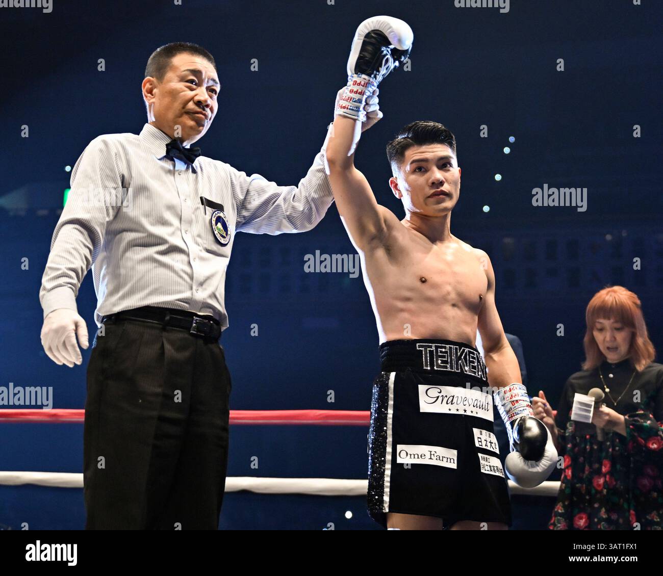 Japan's Tomoya Tsuboi, right, has his arm raised by referee Yuji ...