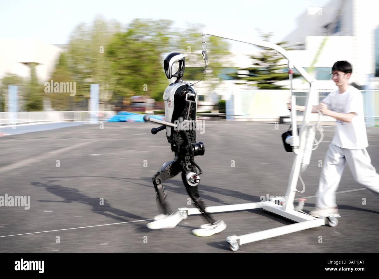 Beijing,China.17th April 2025. A humanoid robot runs at Beijing Esports ...