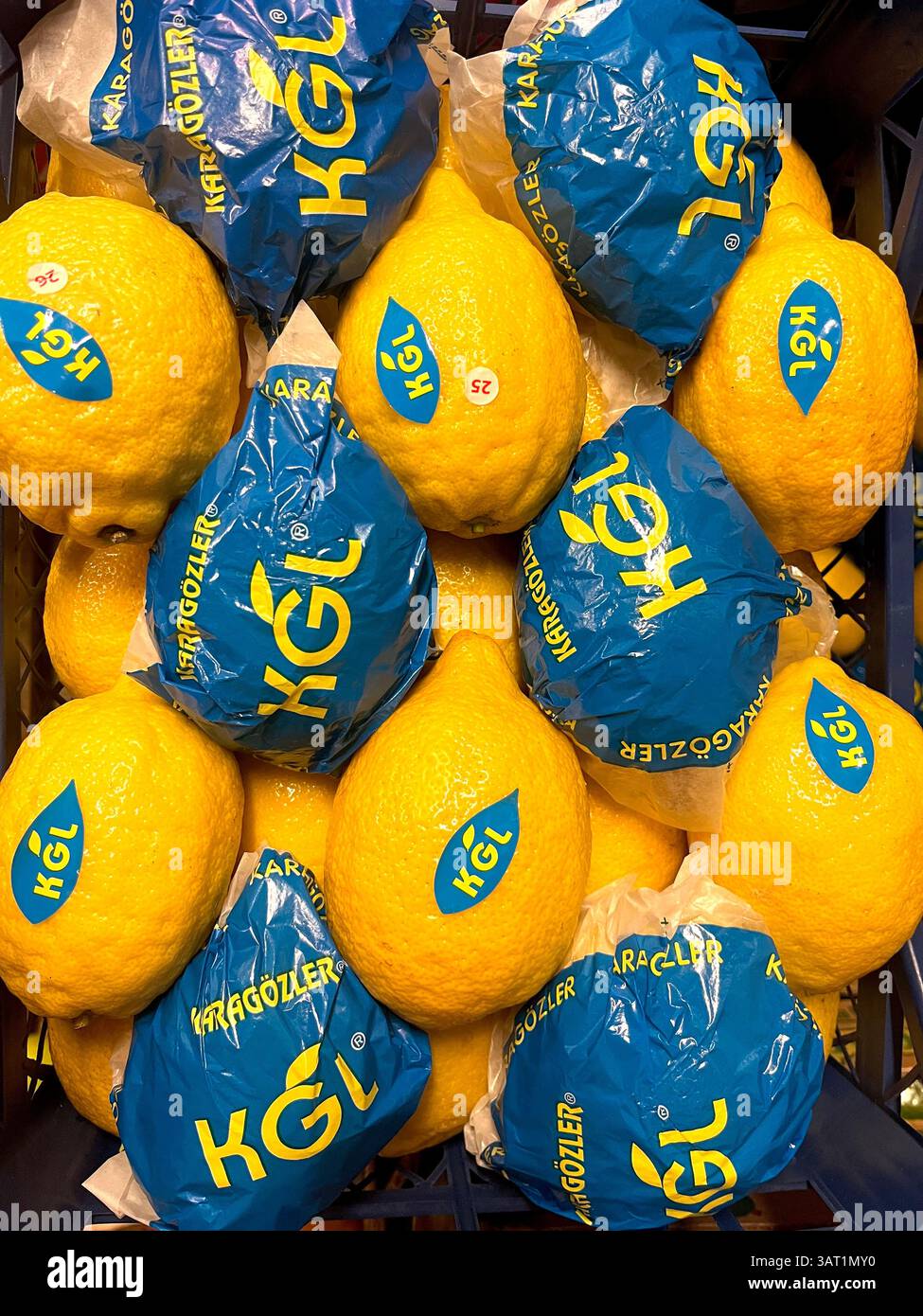 Top view of crate of fresh lemons labeled KGL, produced by Karagözler ...
