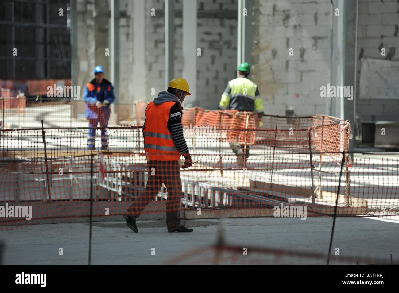 Workers are building a huge complex of pavilions for the EXPO ...