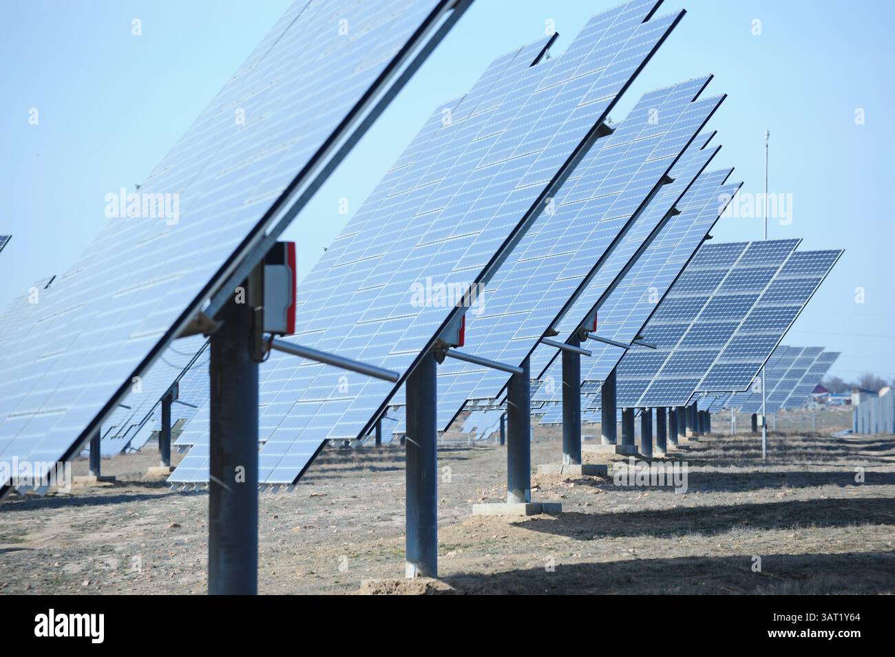 Solar panels of different sizes are lined up in a row to collect energy ...