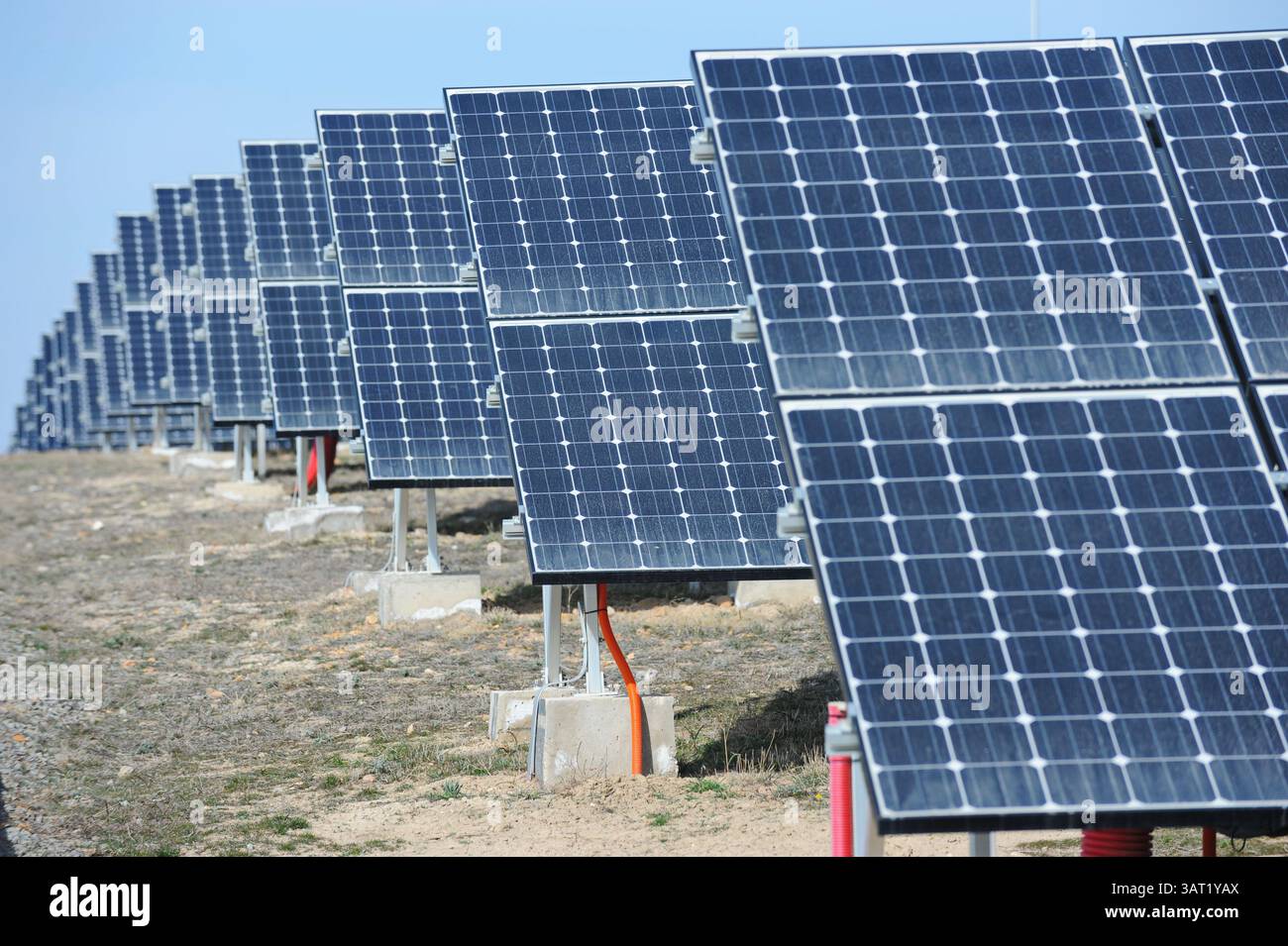 Solar panels of different sizes are lined up in a row to collect energy ...