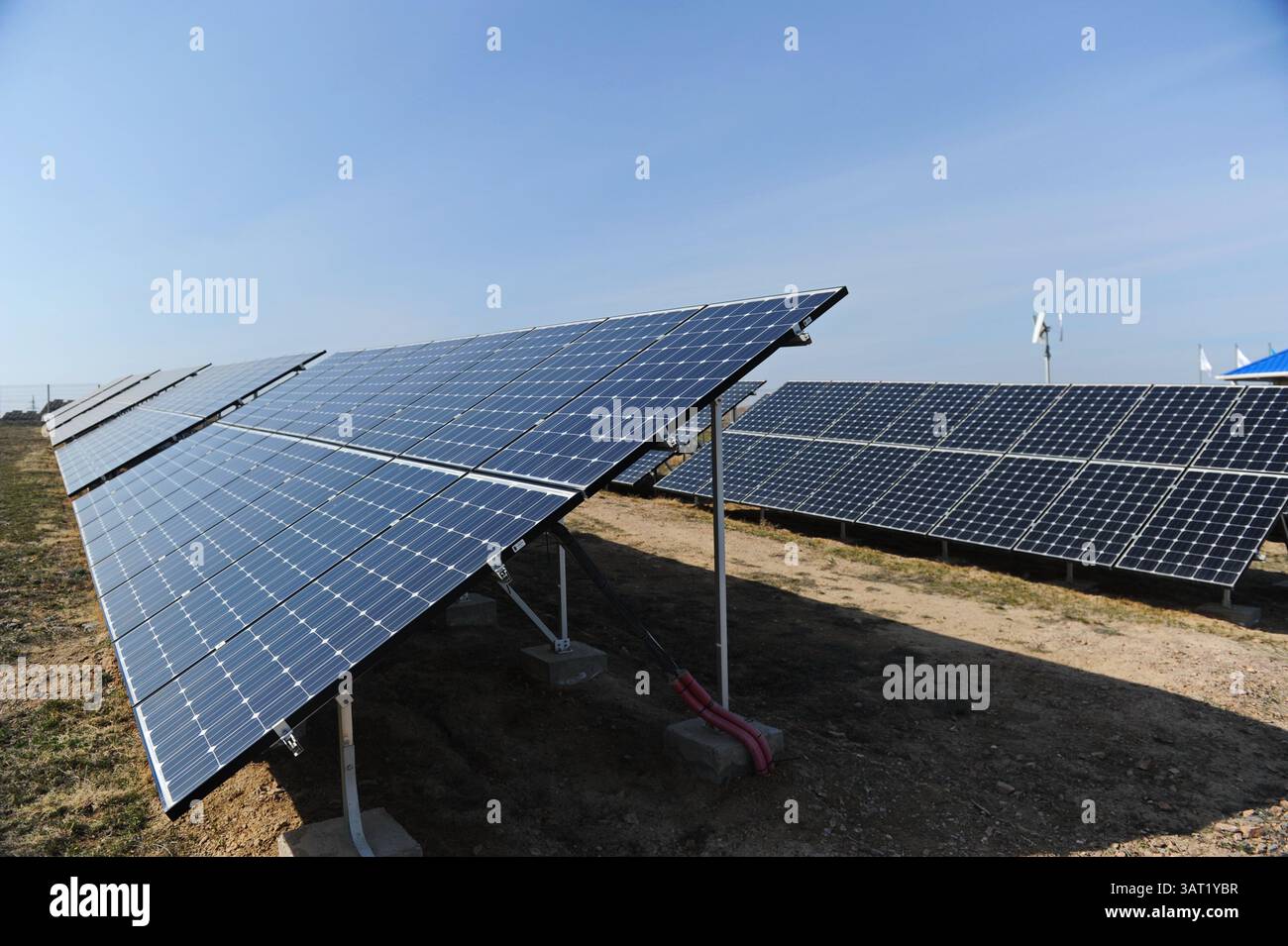 Solar panels of different sizes are lined up in a row to collect energy ...