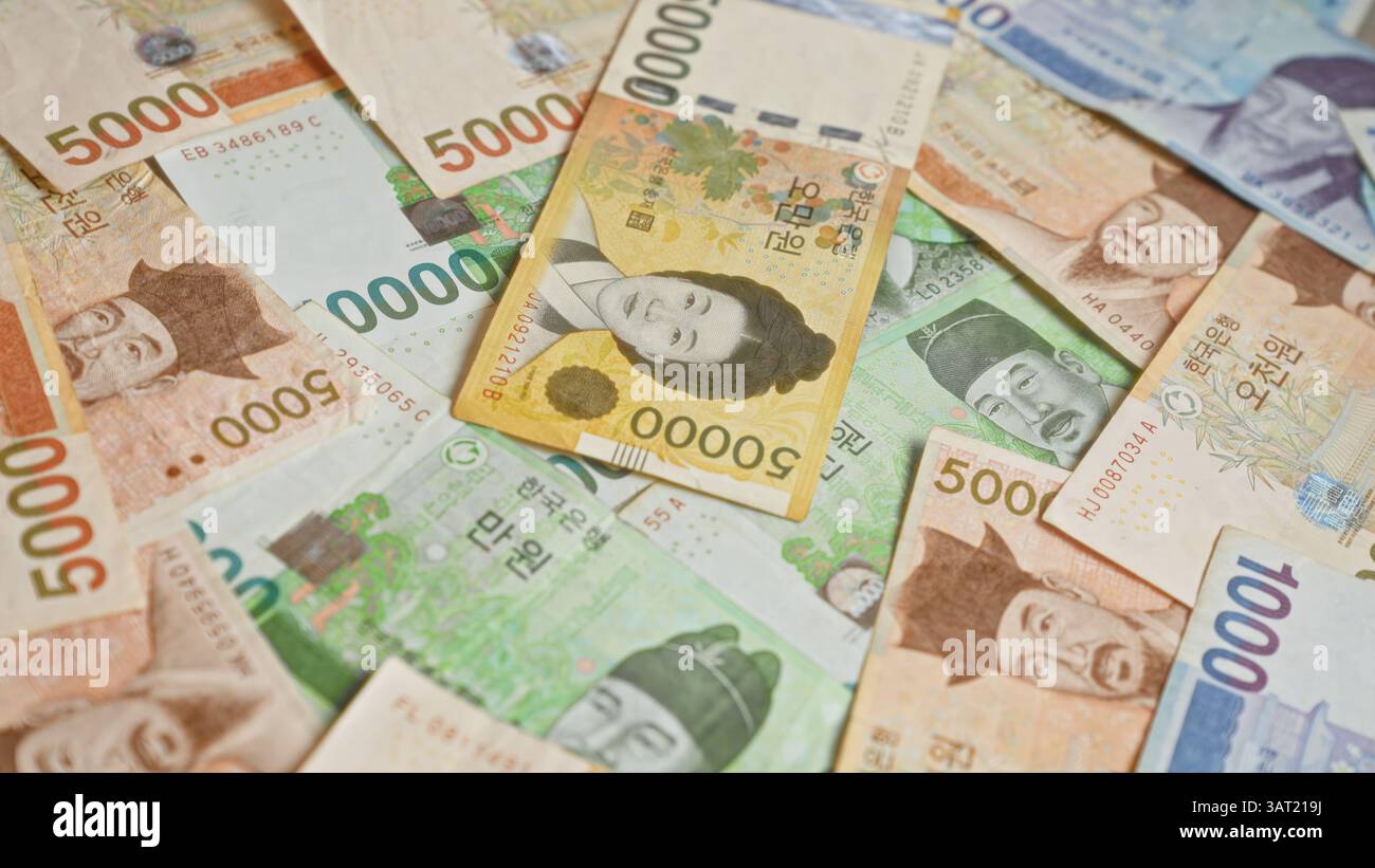 South korean banknotes scattered, featuring colorful won currency notes ...