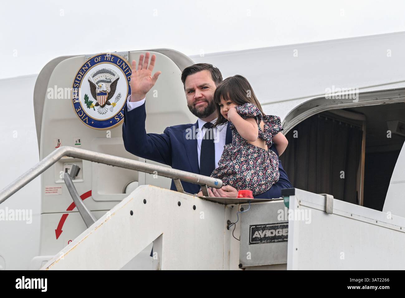 Vice President JD Vance disembarks Air Force Two while carrying his ...