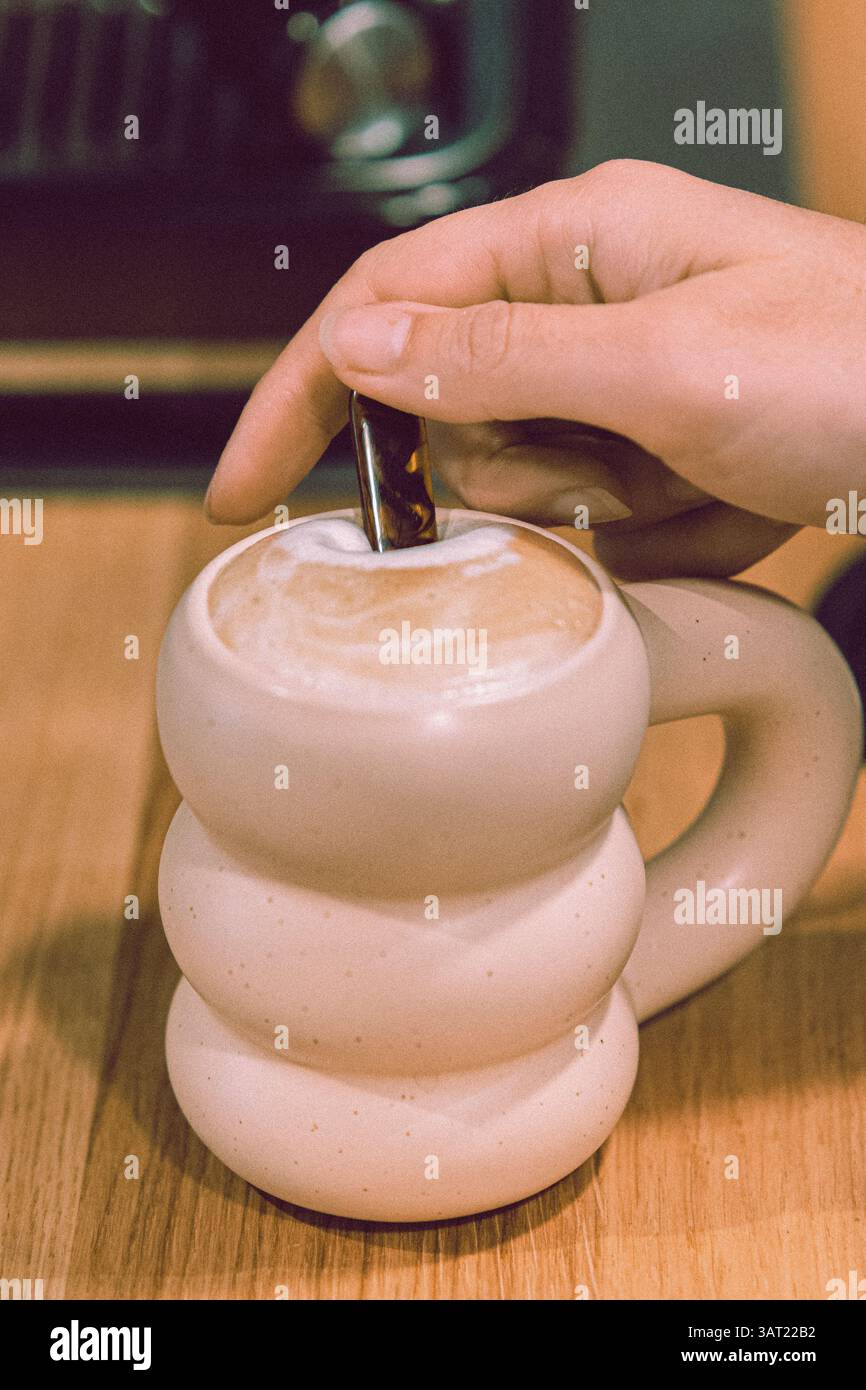 Hand stirring warm creamy beverage hi-res stock photography and images ...