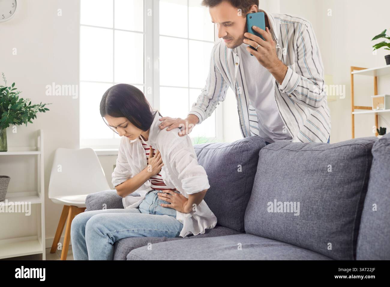 Worried man calling emergency ambulance for his wife with heart attack ...